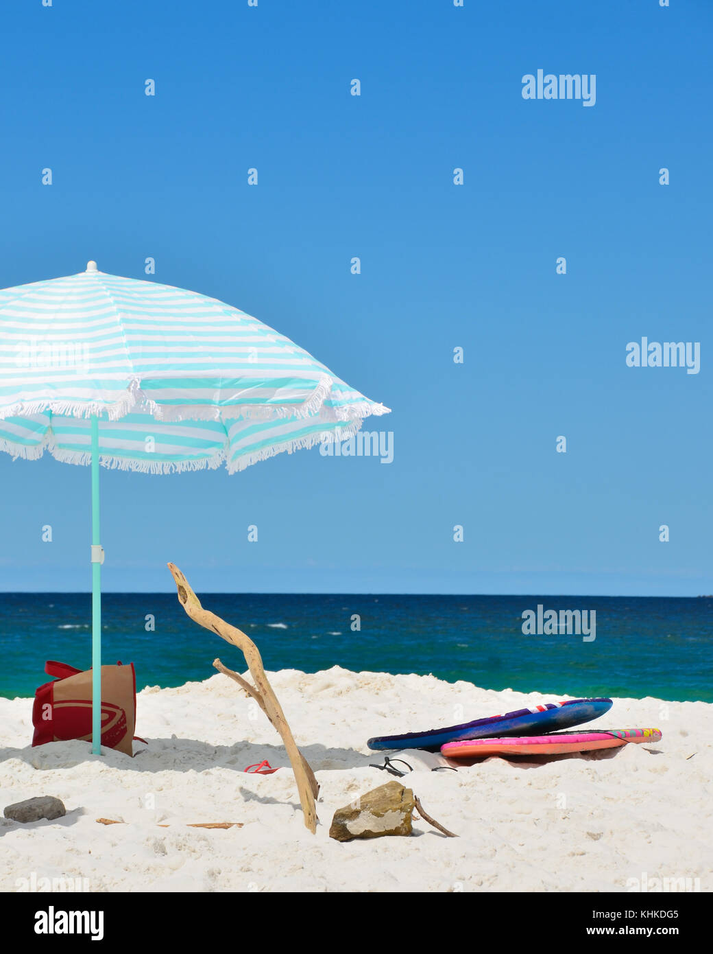 White sand beach with umbrella and beach items. Expectation of summer ...