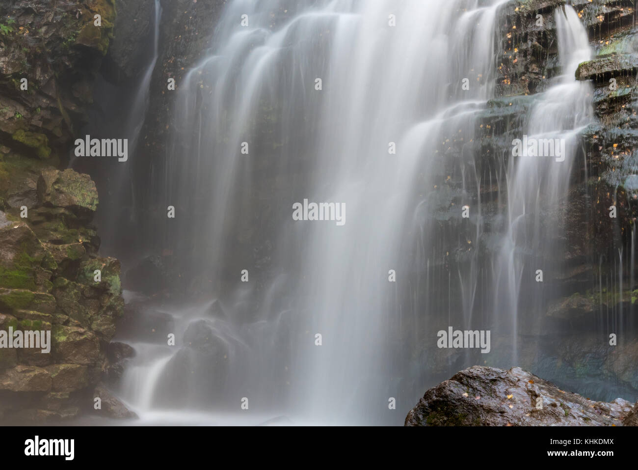 Beautiful view of the waterfall with mist among the rocks and stones ...
