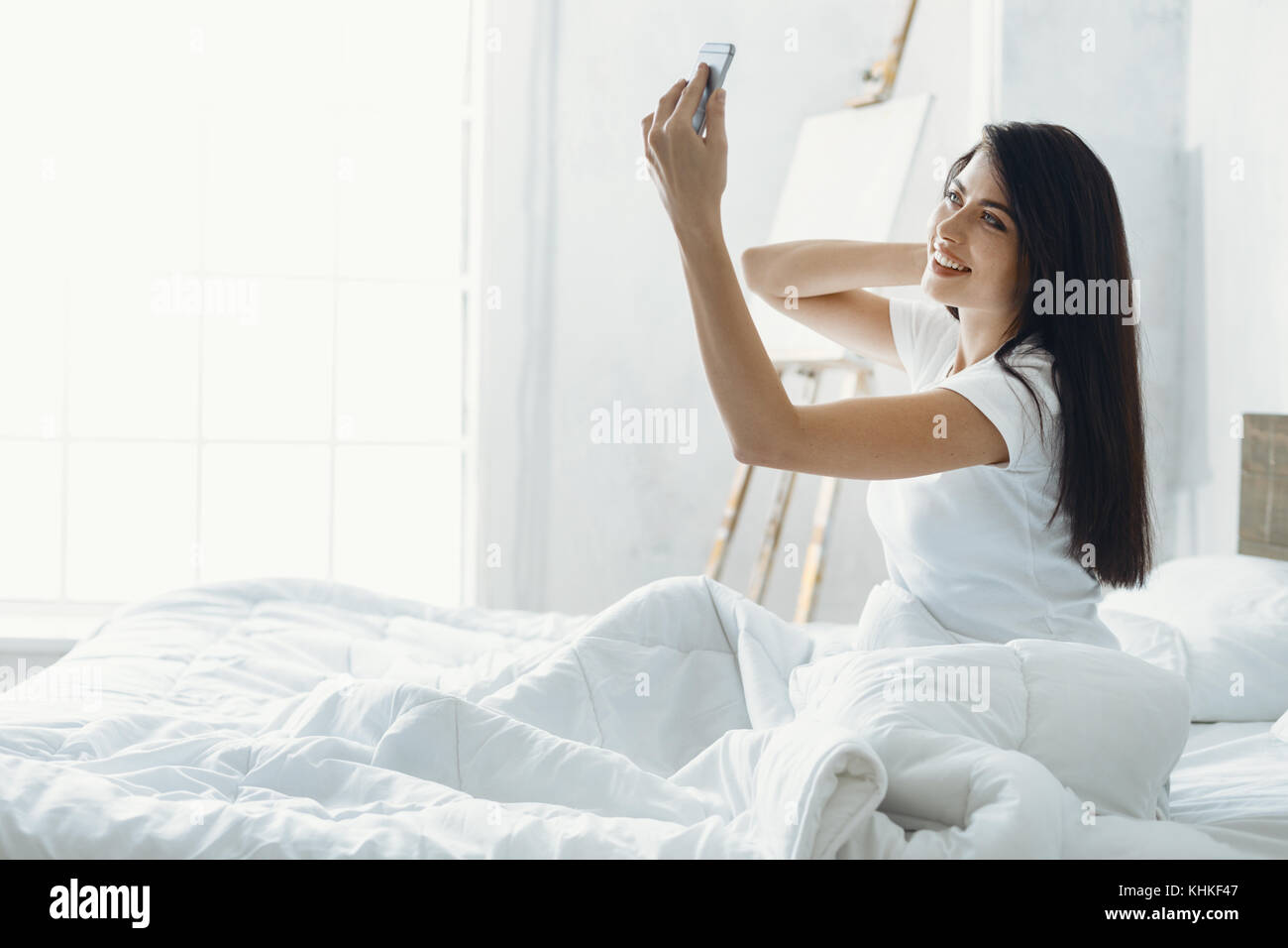 Beautiful female person sitting in semi position Stock Photo - Alamy