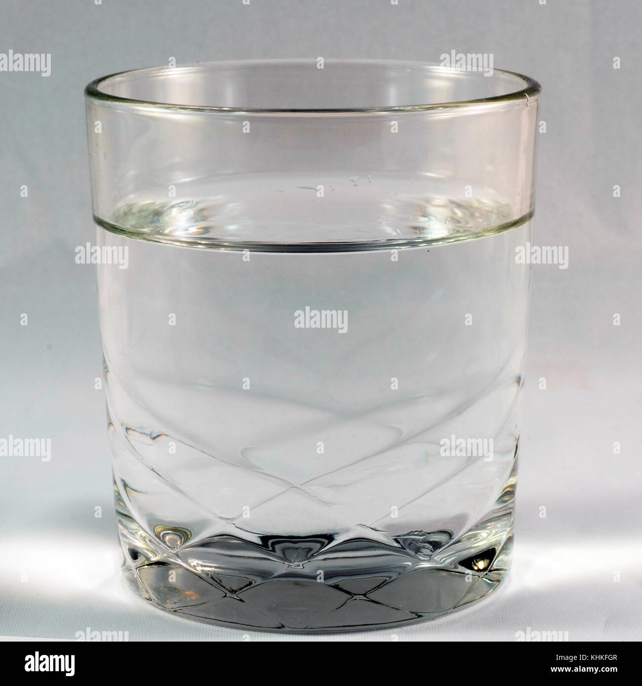 Simple Glass of water on grey background Stock Photo - Alamy