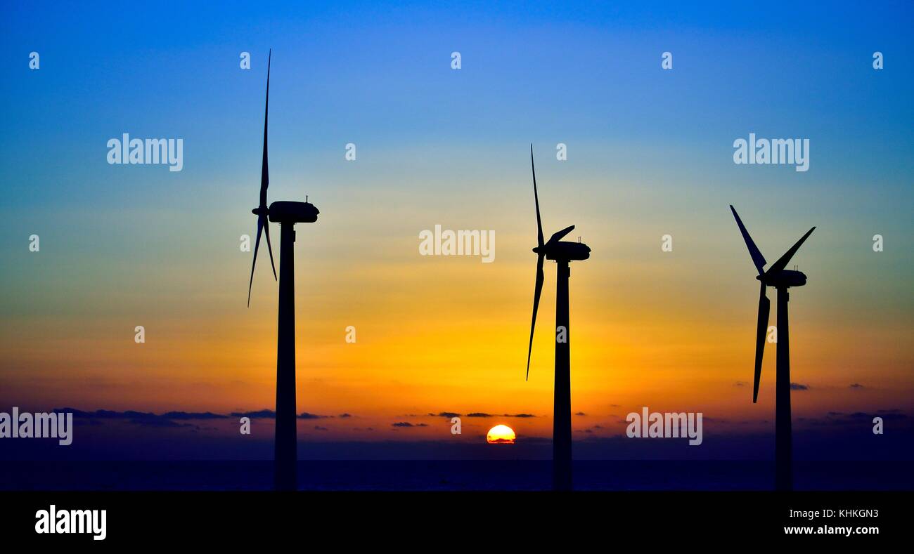 Awesome sunrise, wind turbines and beautiful sky of colors in the ...