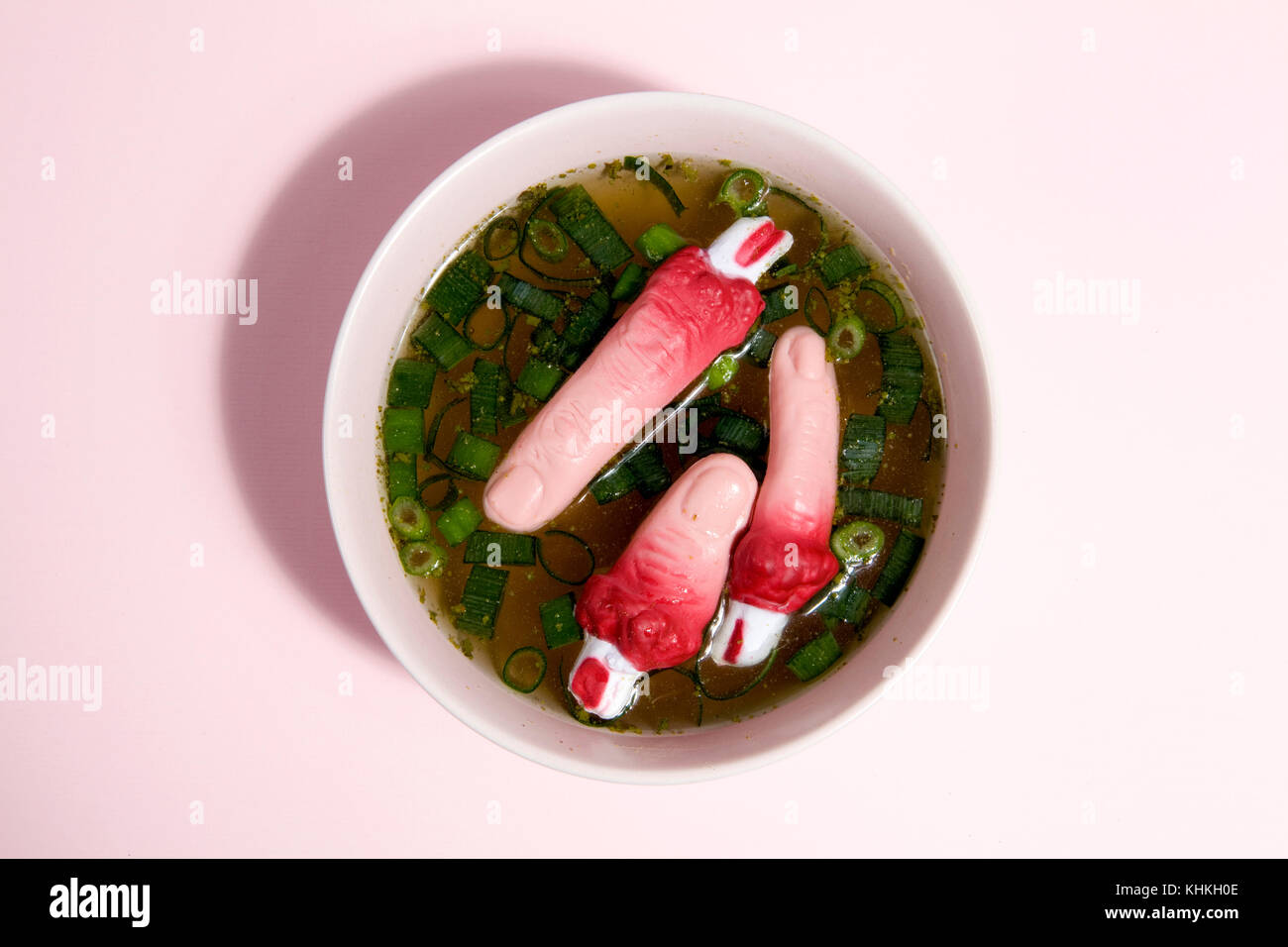 a fingers meat broth with scallions floating on the surface of the soup ...