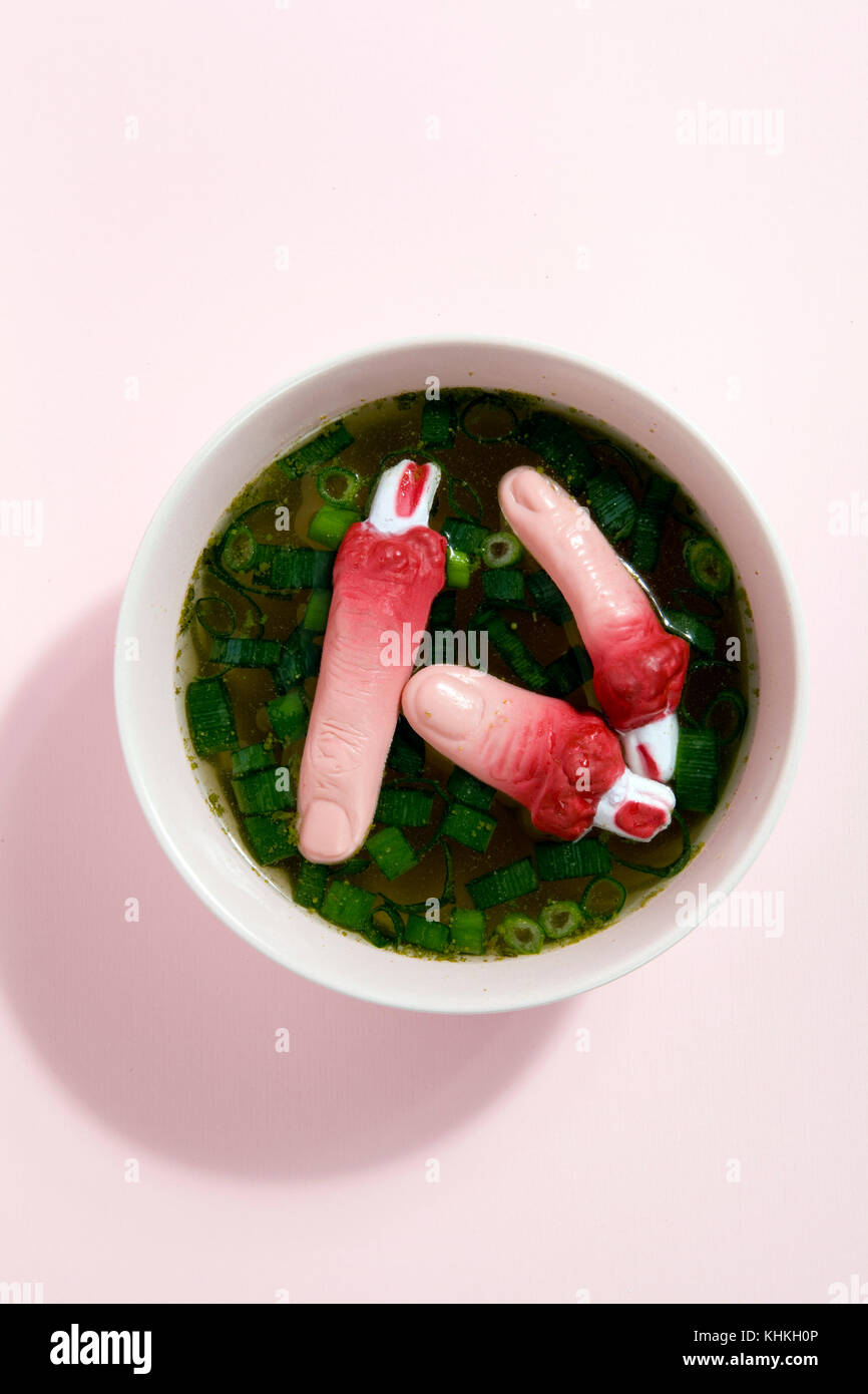 a fingers meat broth with scallions floating on the surface of the soup ...