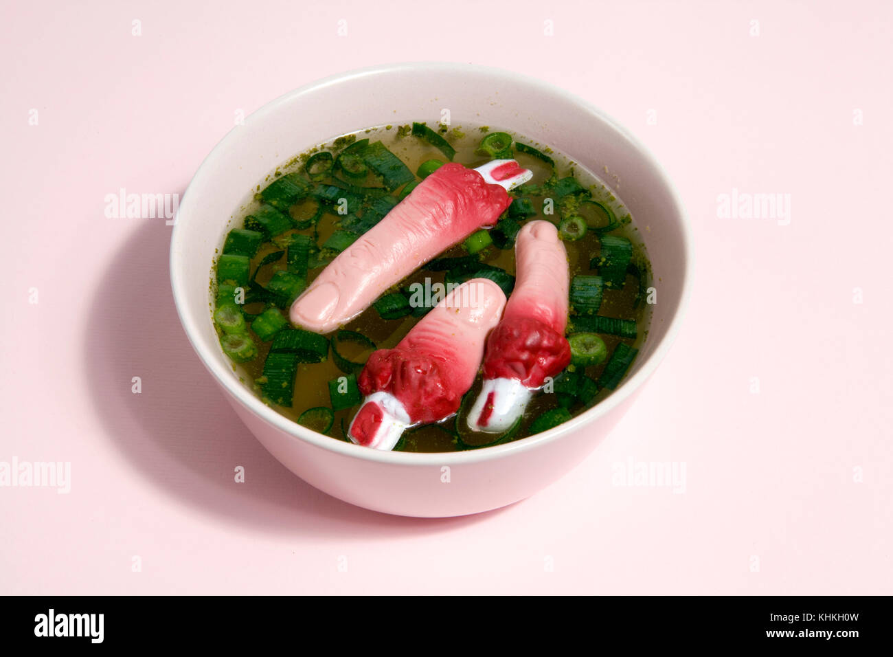 a fingers meat broth with scallions floating on the surface of the soup ...
