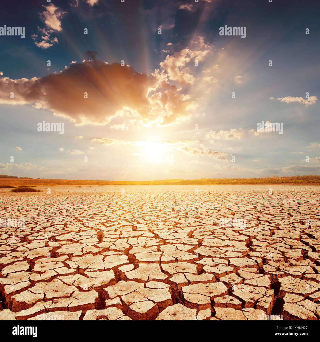 red sunset over cracked earth Stock Photo - Alamy