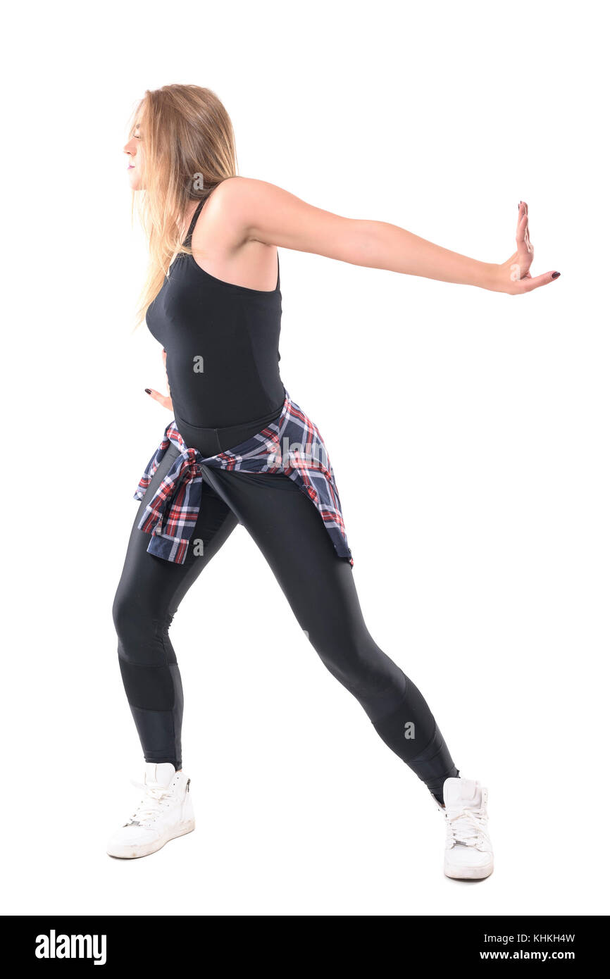 Profile view of active energetic female jazz dance dancer with arms ...