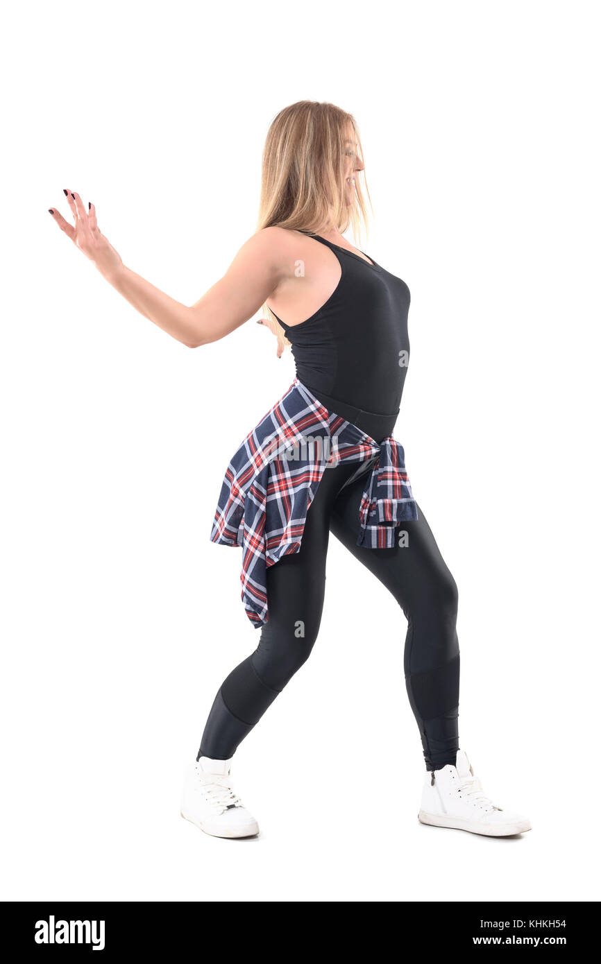 Side view of attractive smiling blonde dancer posture looking away ...