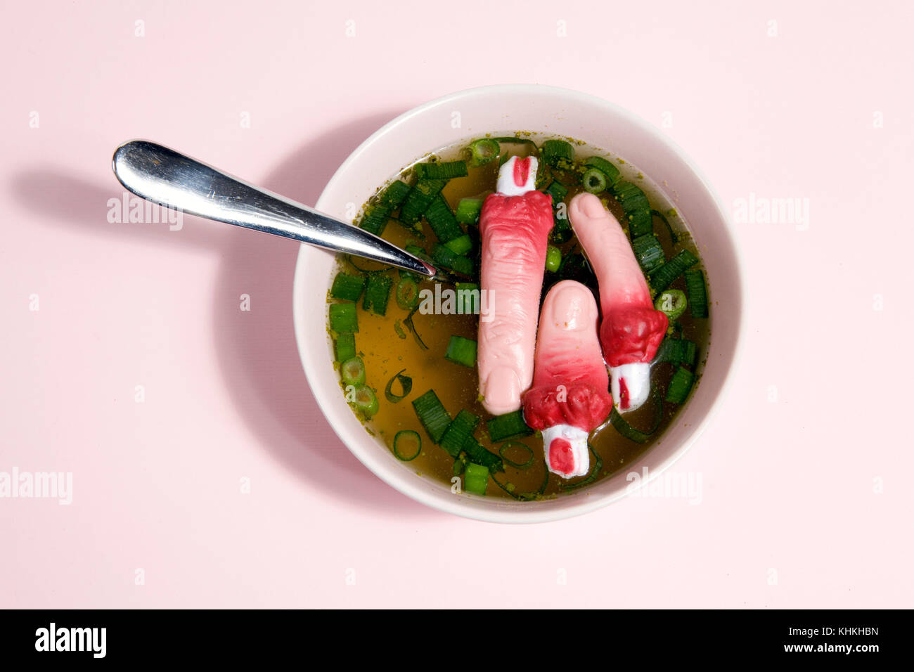 a fingers meat broth with scallions floating on the surface of the soup ...