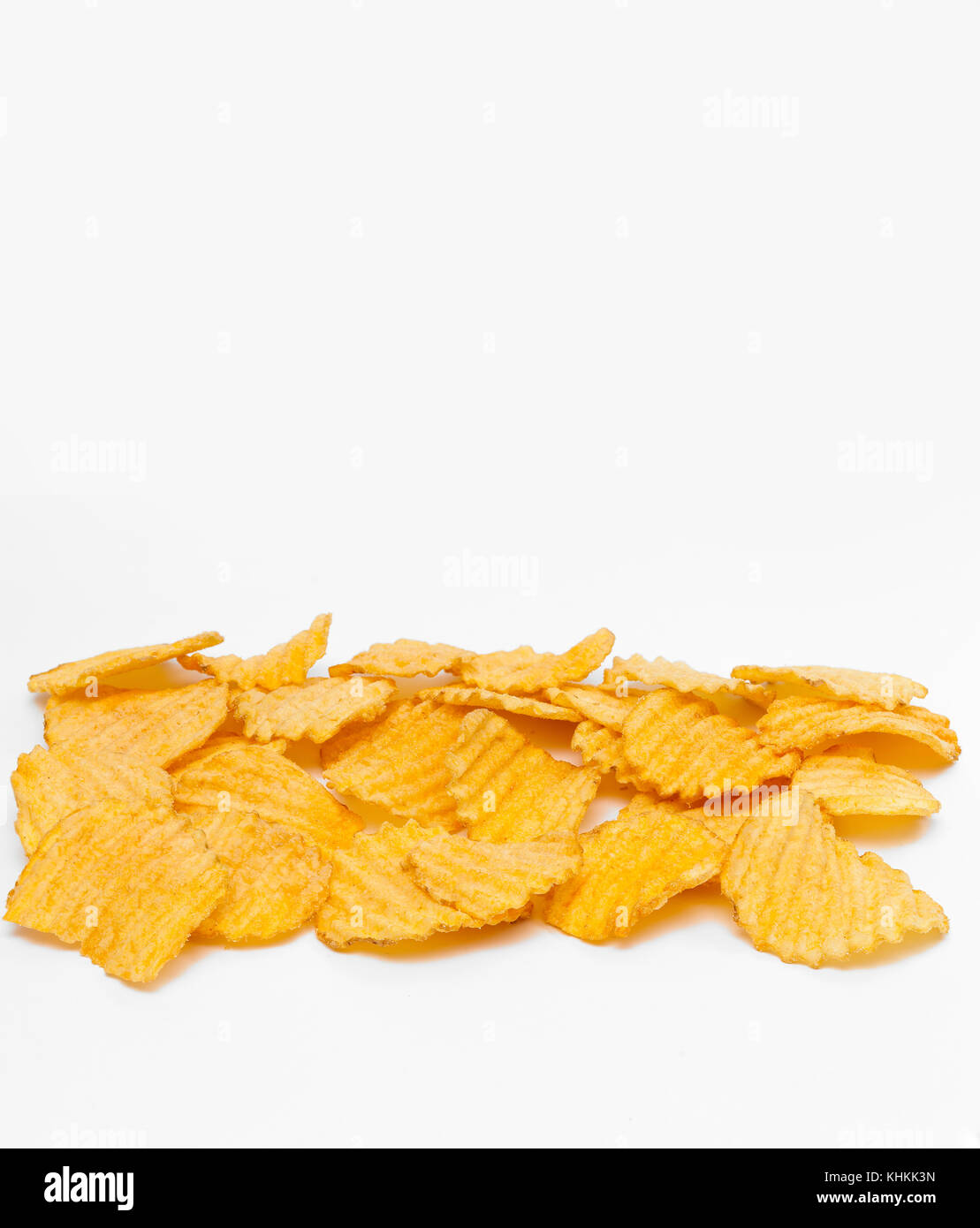 Ribbed potato chips with spices on white background Stock Photo - Alamy