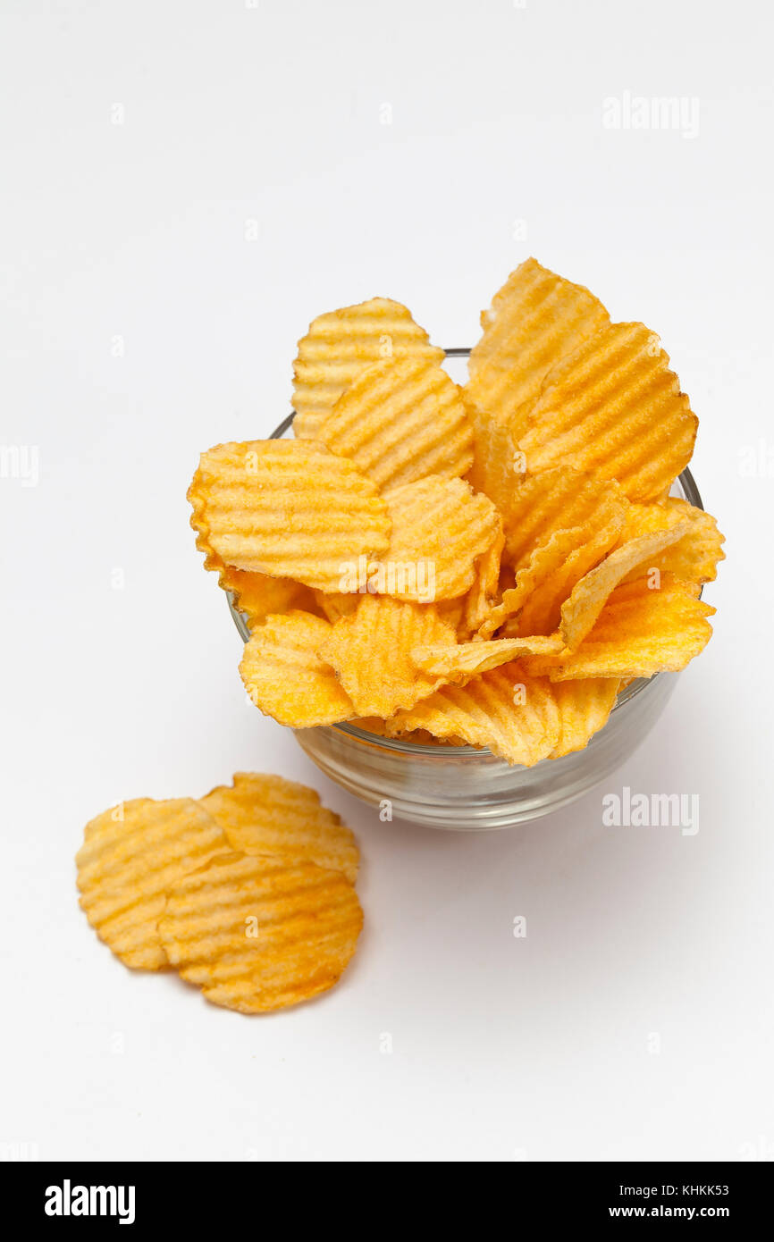 Ribbed potato chips with spices on white background Stock Photo - Alamy