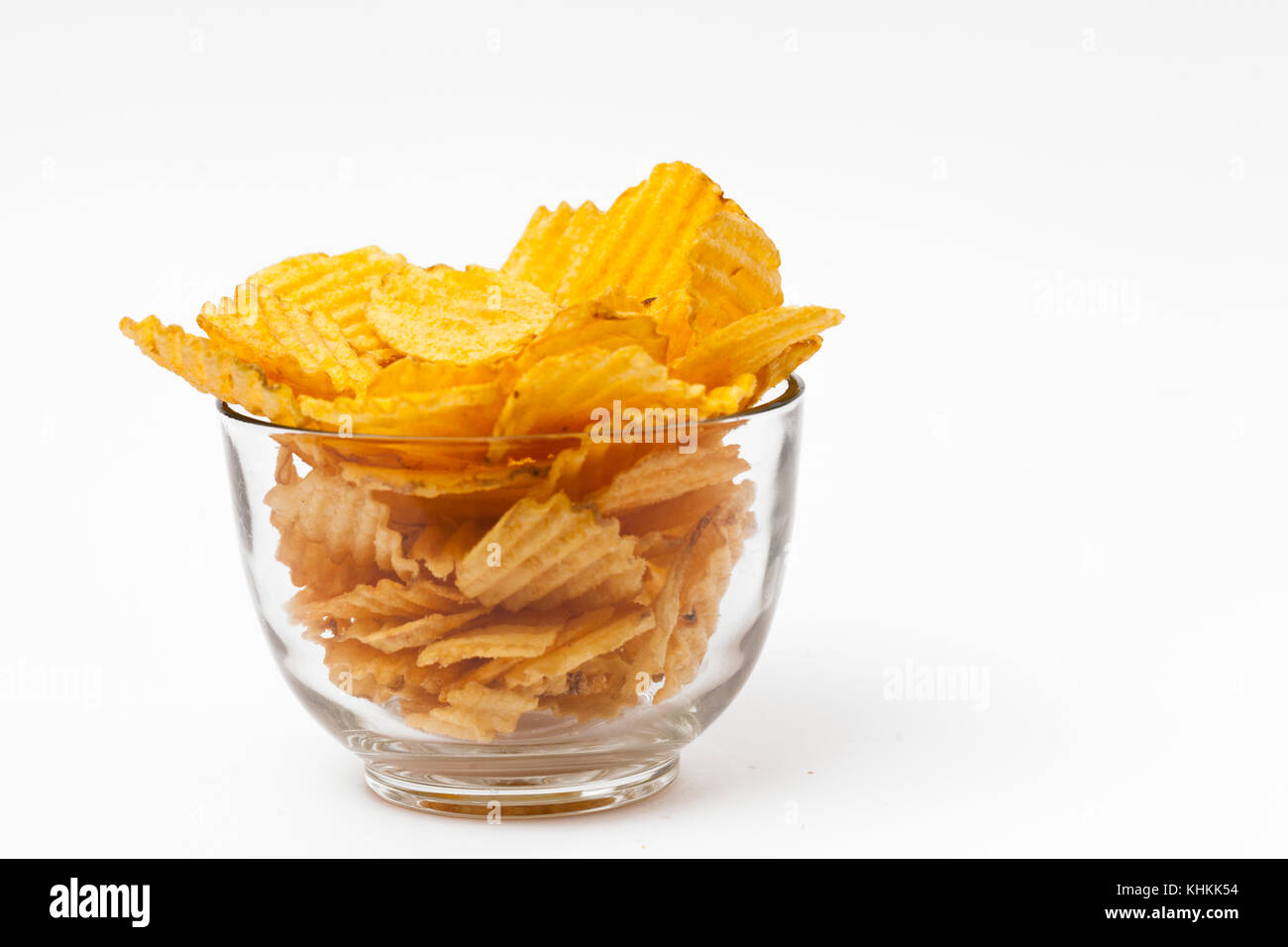 Ribbed potato chips with spices on white background Stock Photo - Alamy