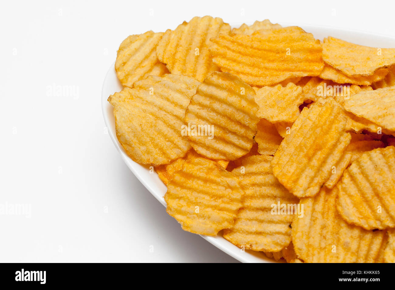 Ribbed potato chips with spices on white background Stock Photo - Alamy