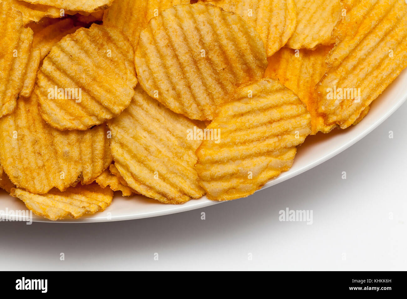 Ribbed potato chips with spices on white background Stock Photo - Alamy