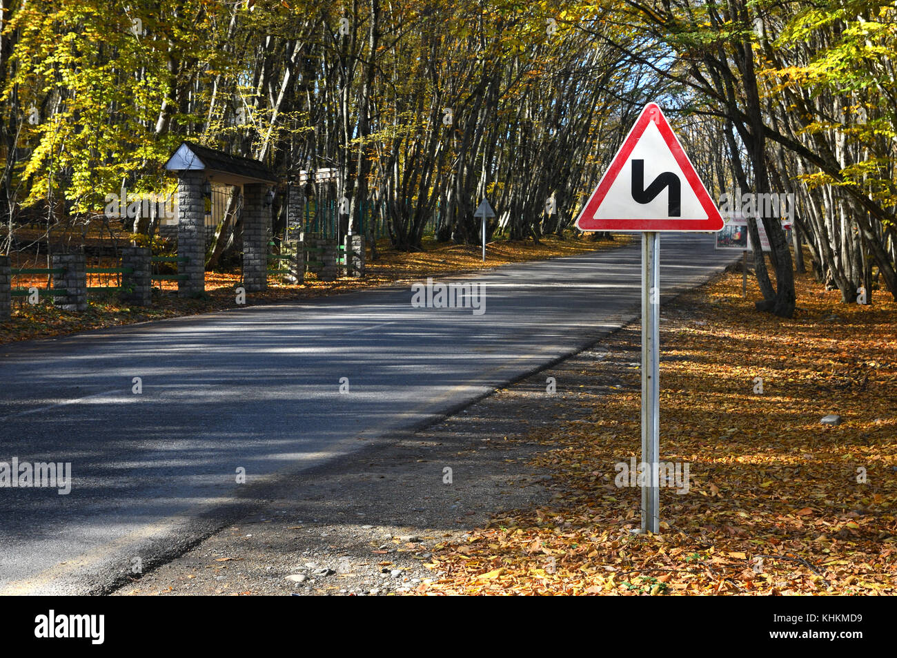 Sign at the forestroad.A warning of asteep turn Stock Photo - Alamy