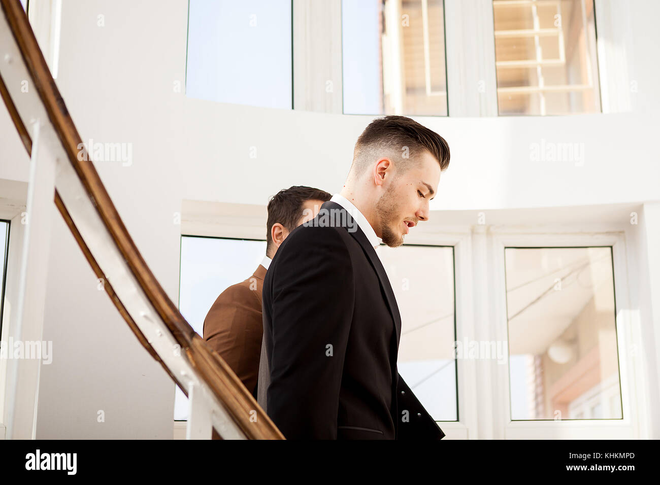 Two male business partners walking and talking Stock Photo - Alamy