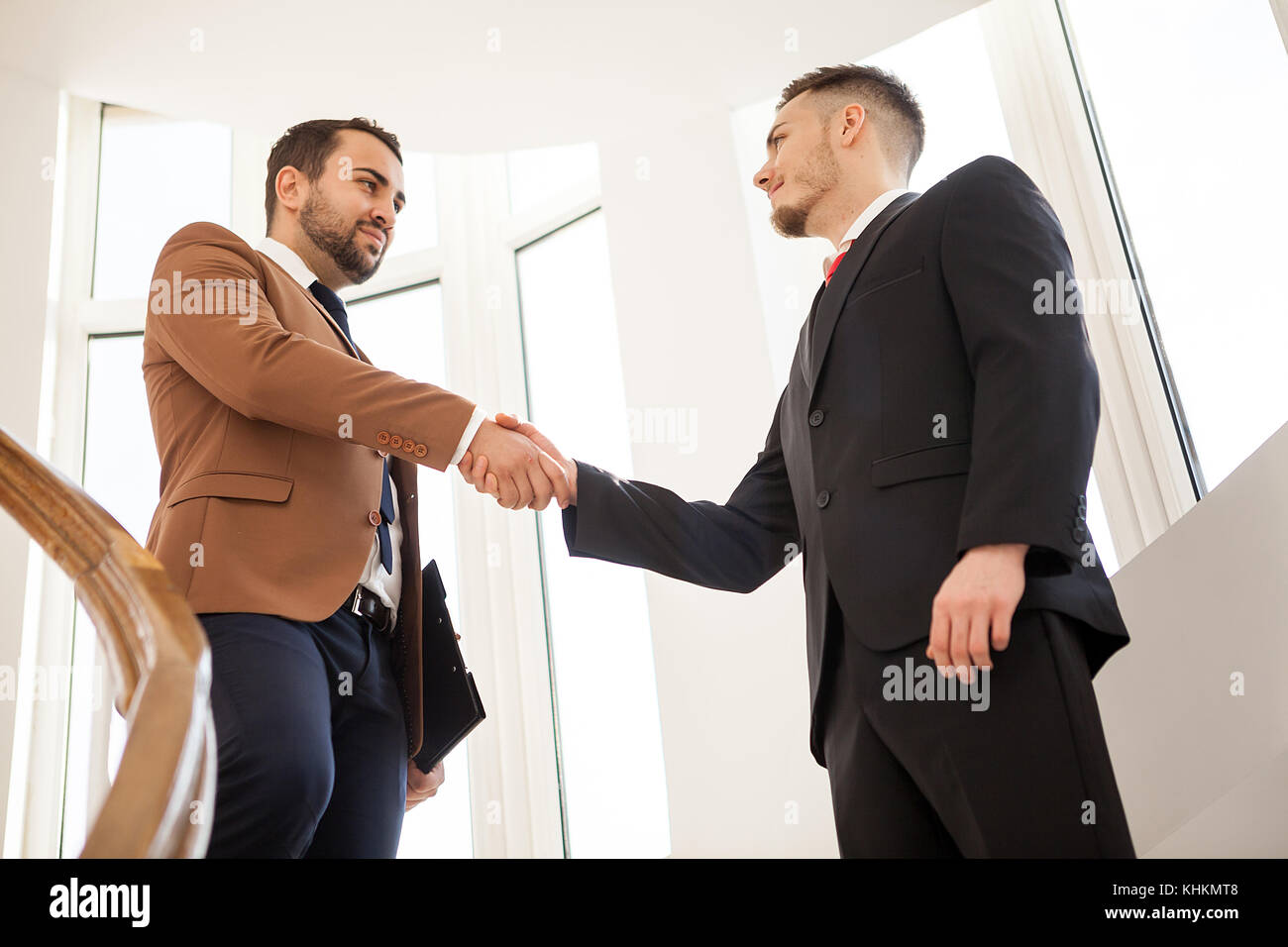 Partners shake hands in office hi-res stock photography and images - Alamy
