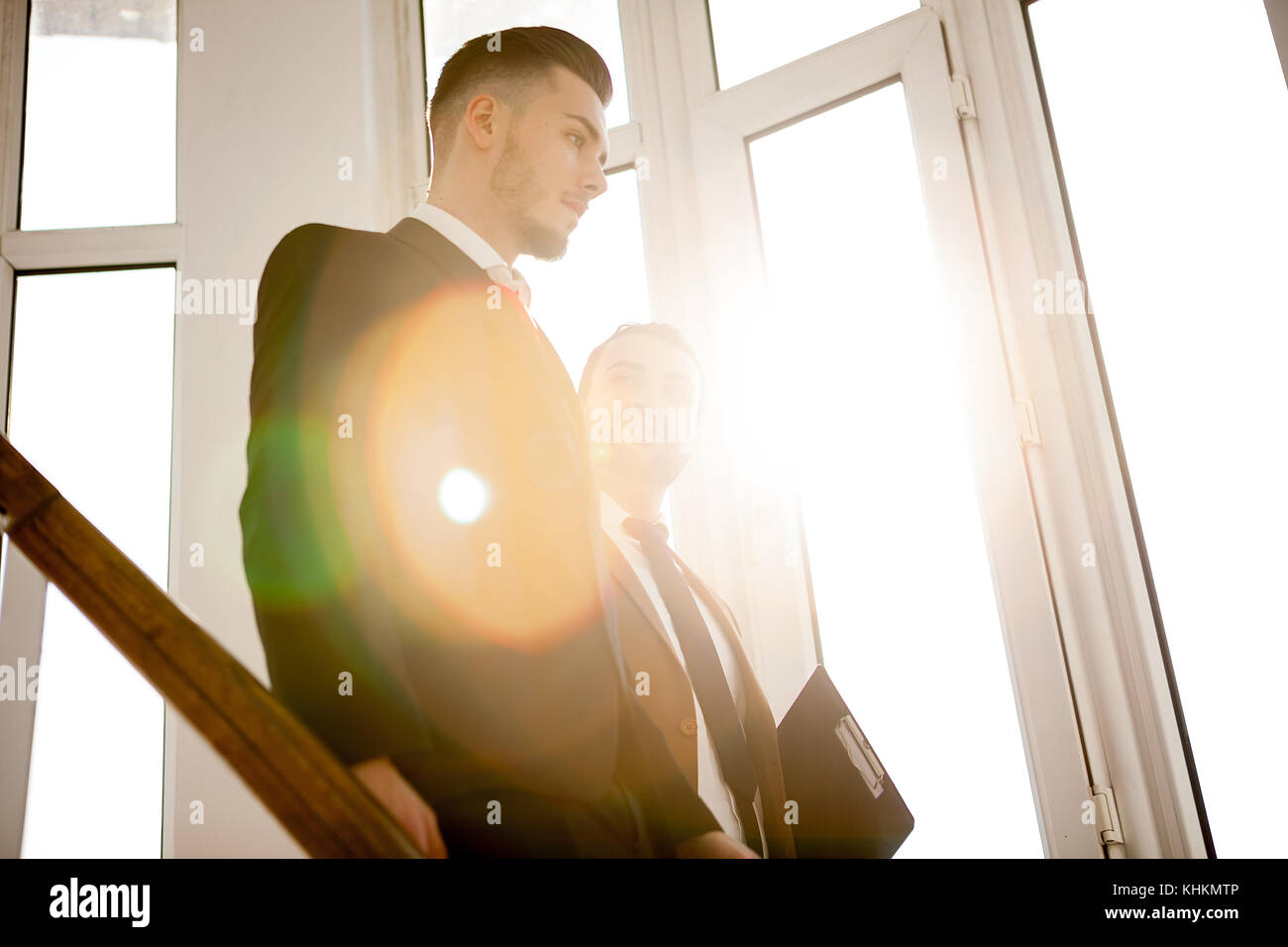 Two business men in the rays of light in office Stock Photo - Alamy