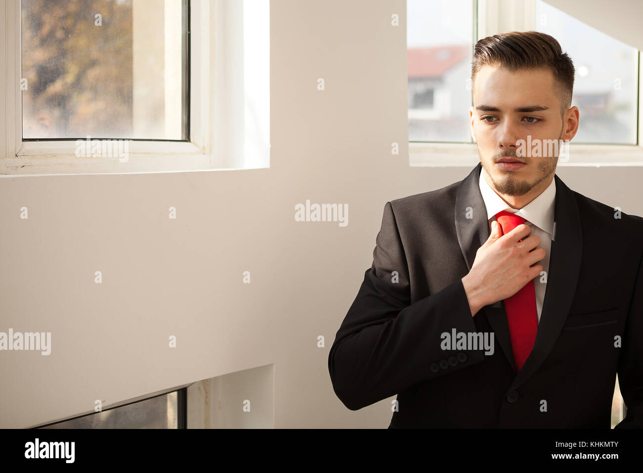 Business man in suit in office building interior Stock Photo - Alamy