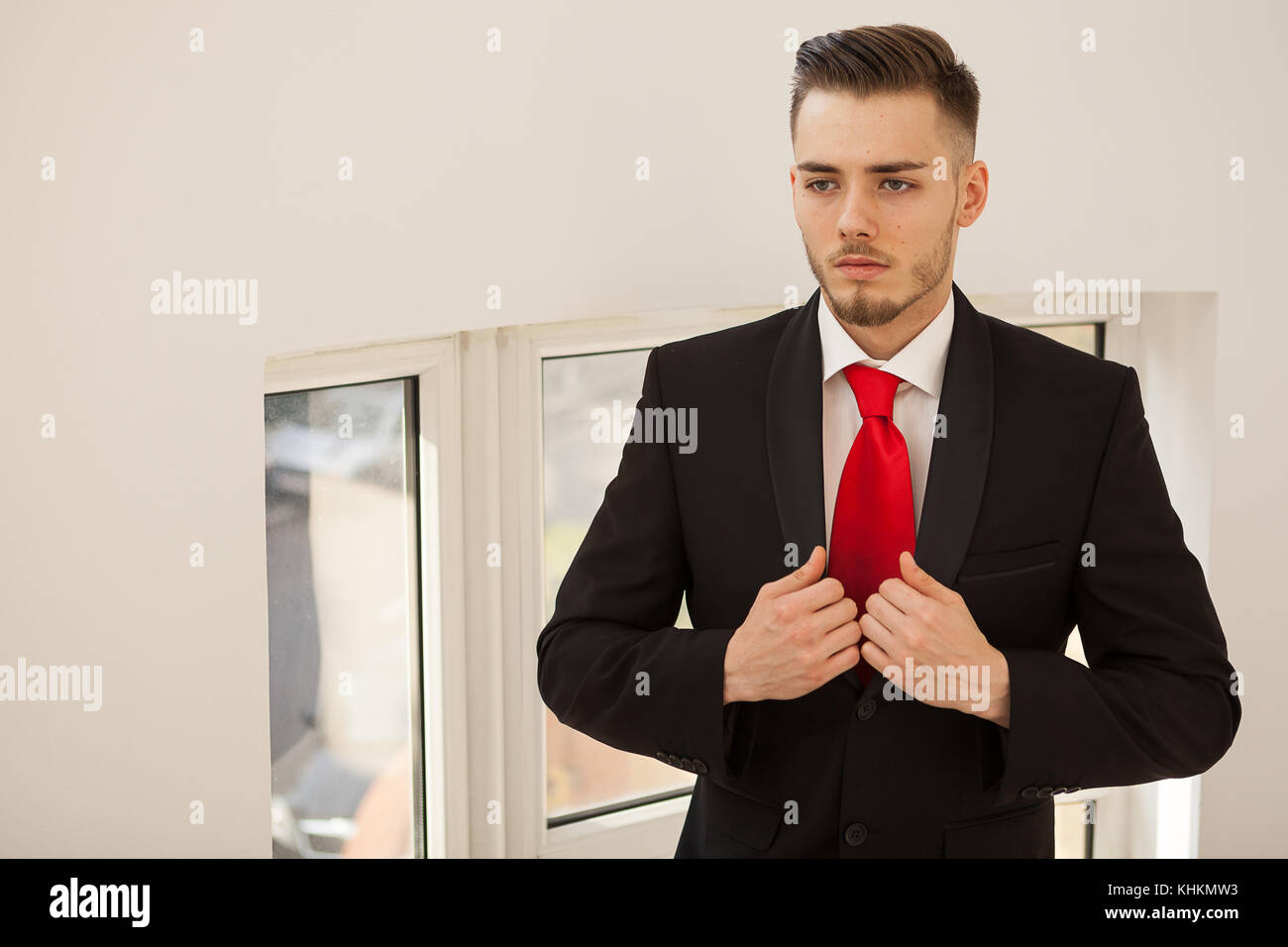 Business man in suit in office building interior Stock Photo - Alamy