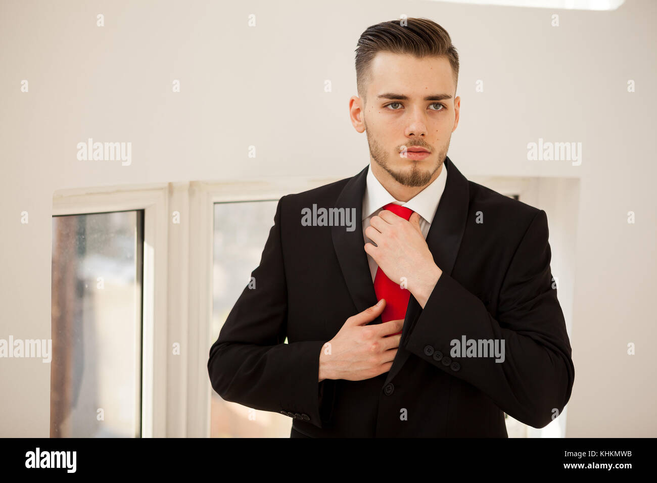 Business man in suit in office building interior Stock Photo - Alamy