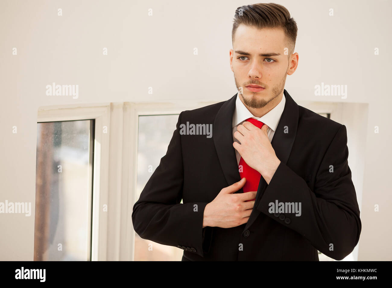 Business man in suit in office building interior Stock Photo - Alamy