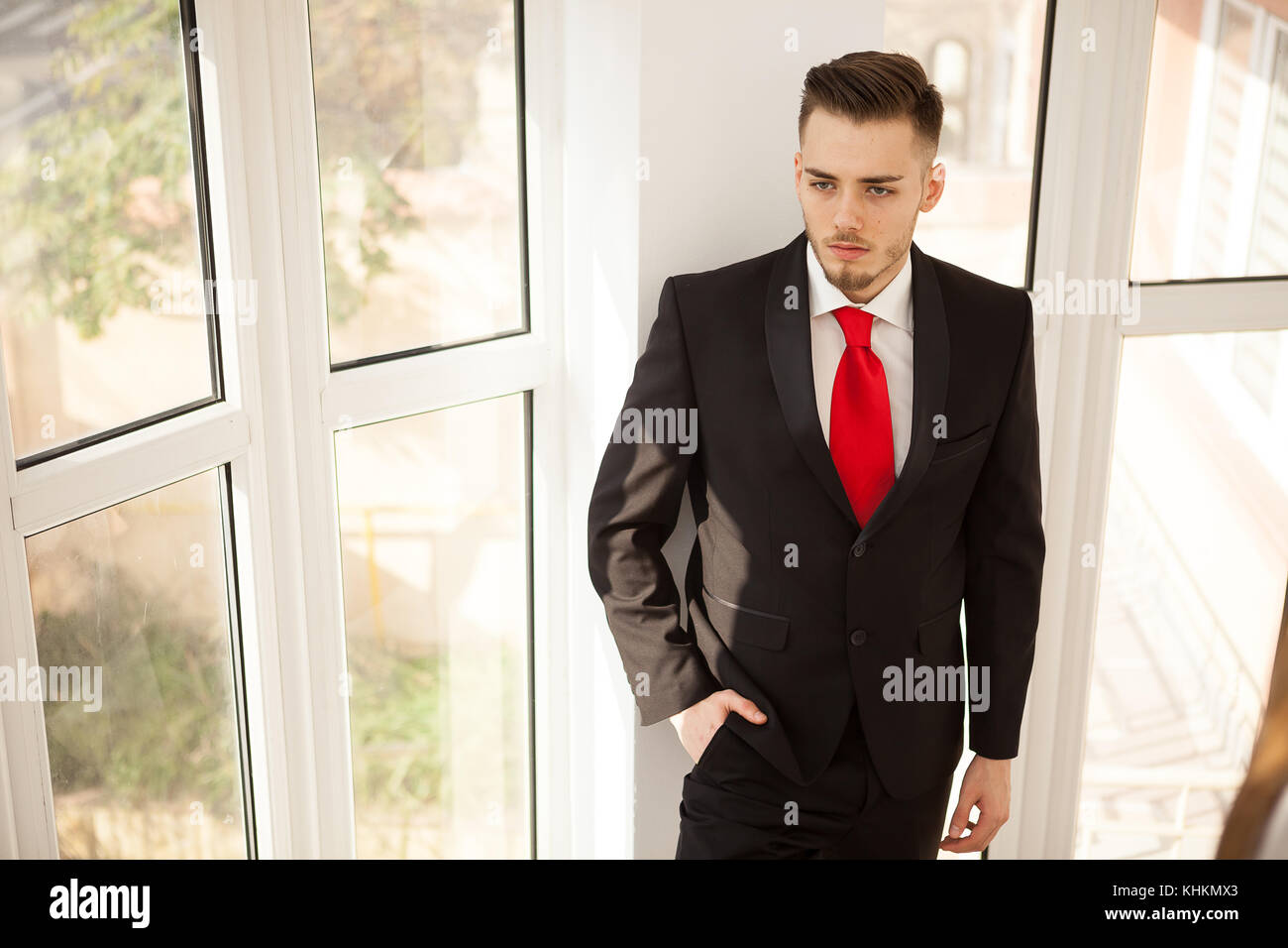 Business man in suit in office building interior Stock Photo - Alamy