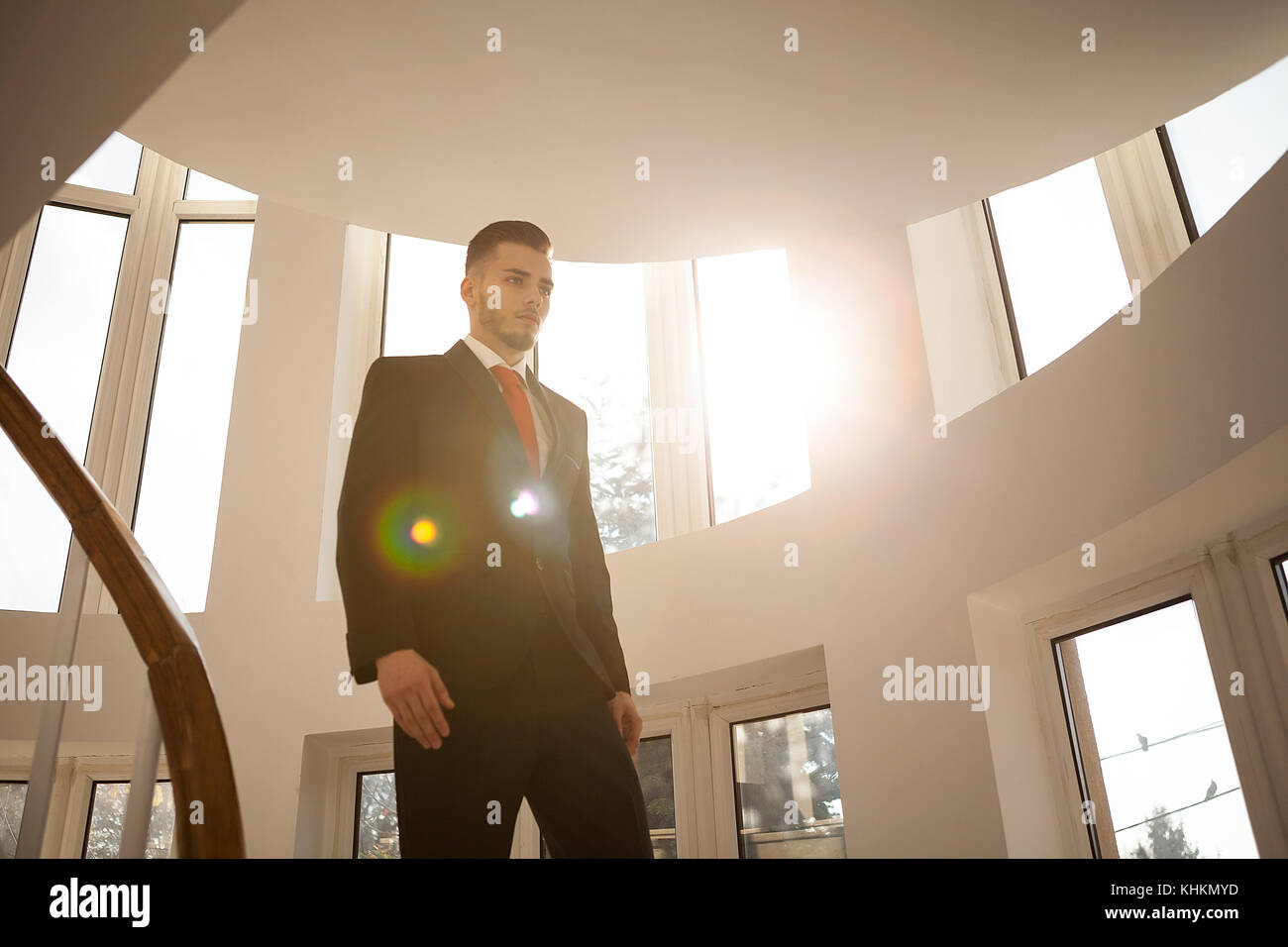 Business man in suit in office building interior Stock Photo - Alamy