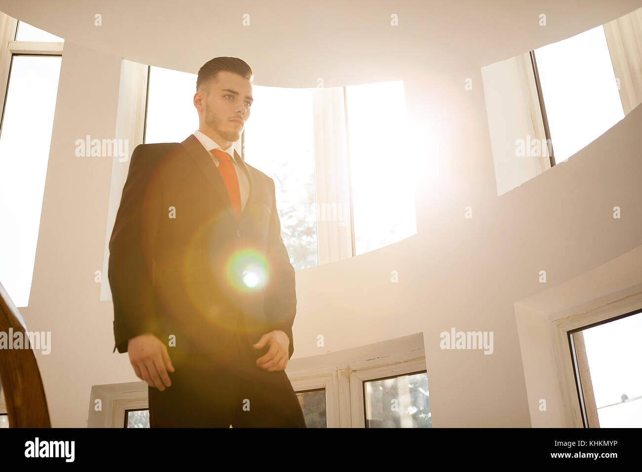 Business man in suit in office building interior Stock Photo - Alamy