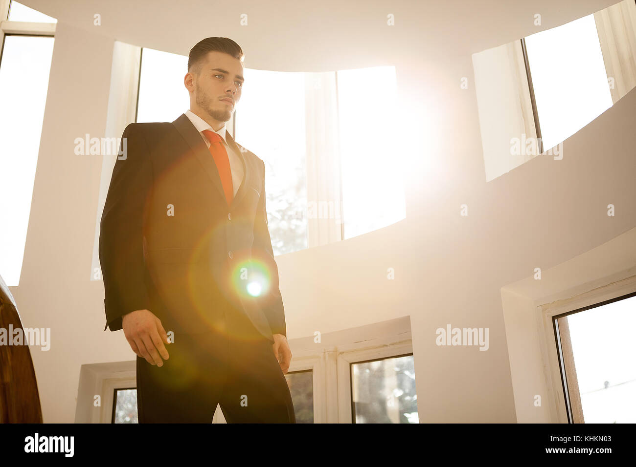 Business man in suit in office building interior Stock Photo - Alamy