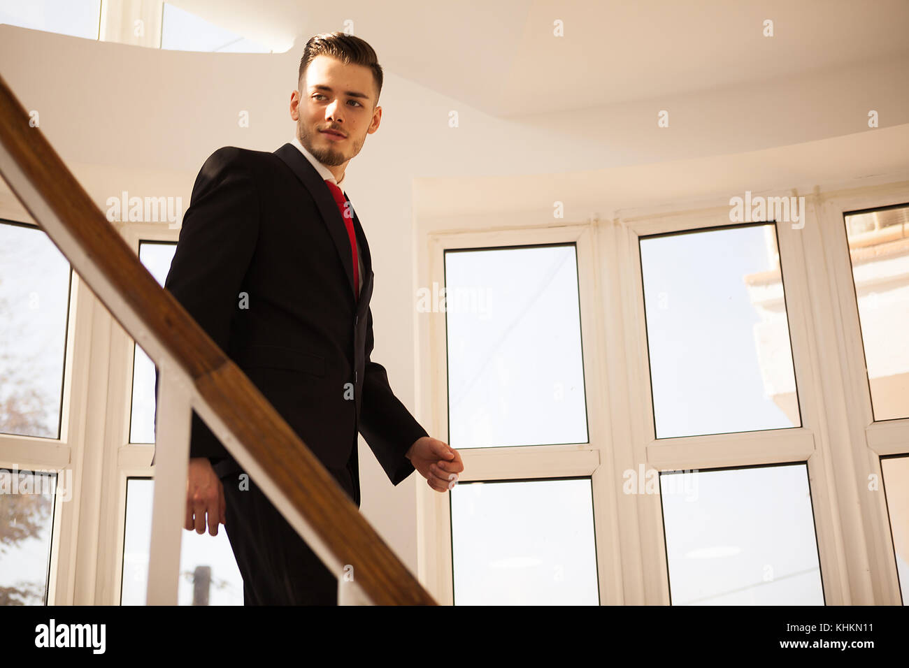 Business man in suit in office building interior Stock Photo - Alamy