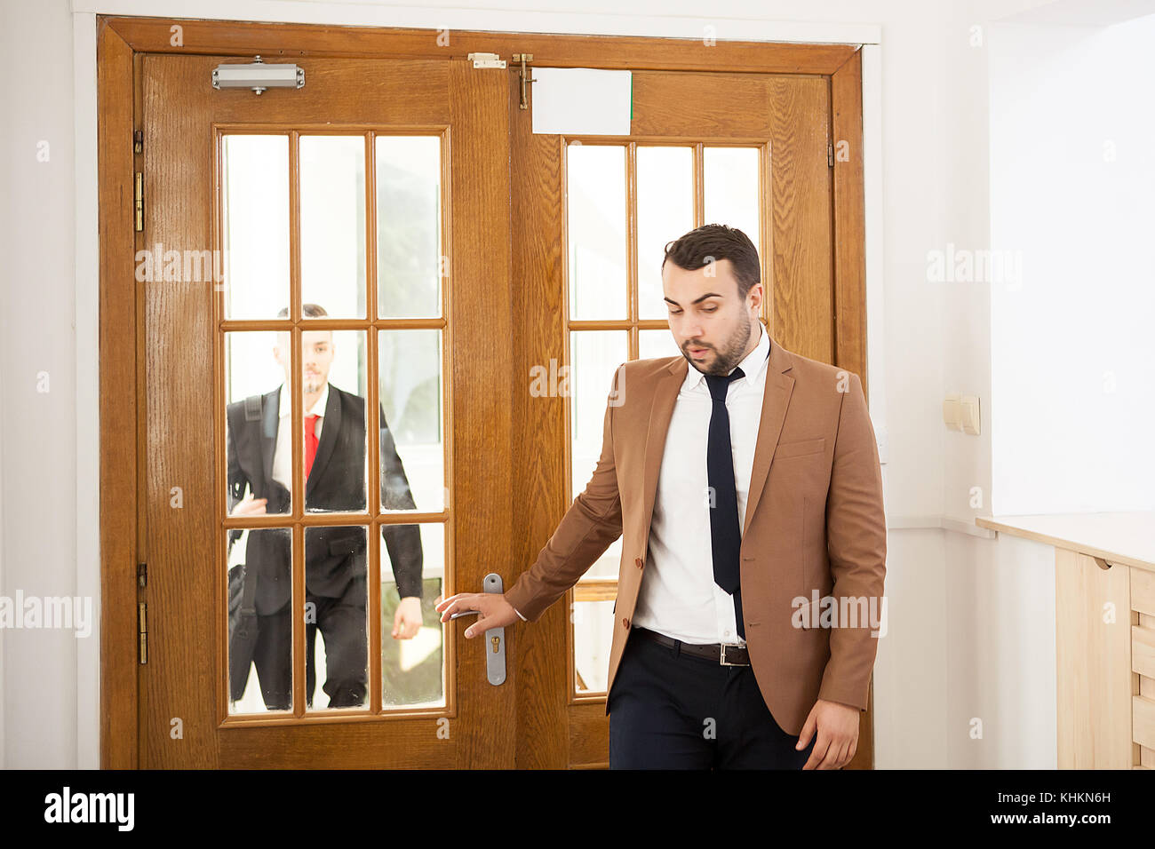 Successful businessman entering his office Stock Photo - Alamy