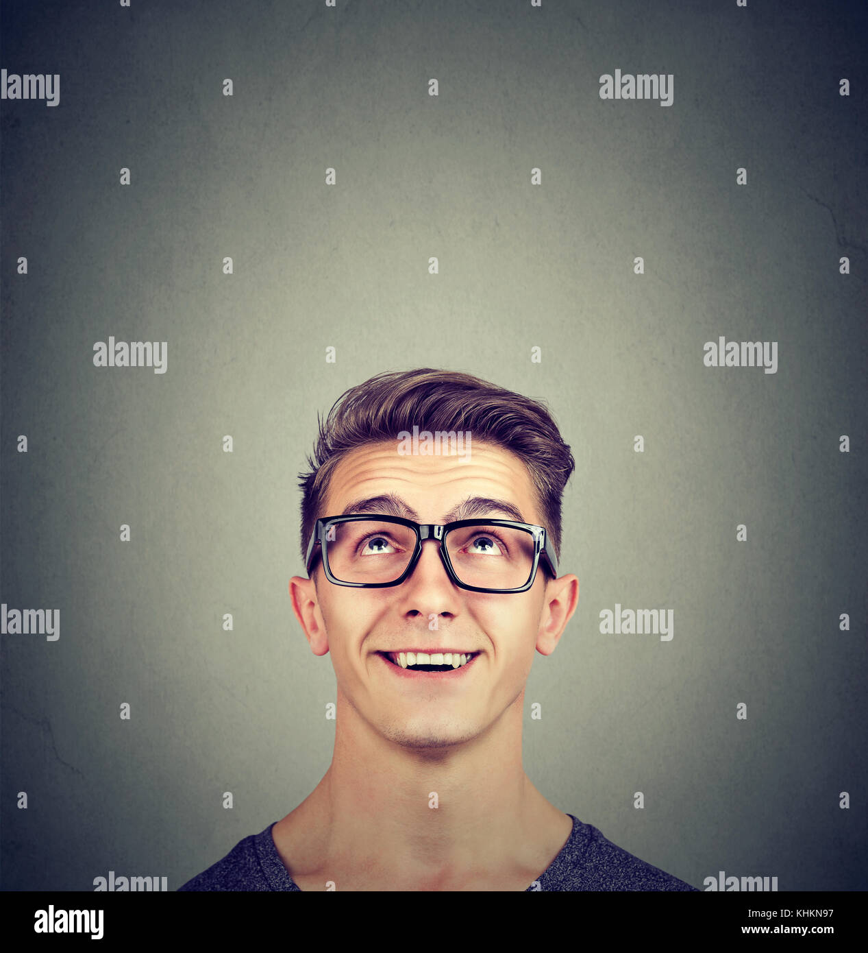 Surprised happy man wearing glasses looking up Stock Photo - Alamy
