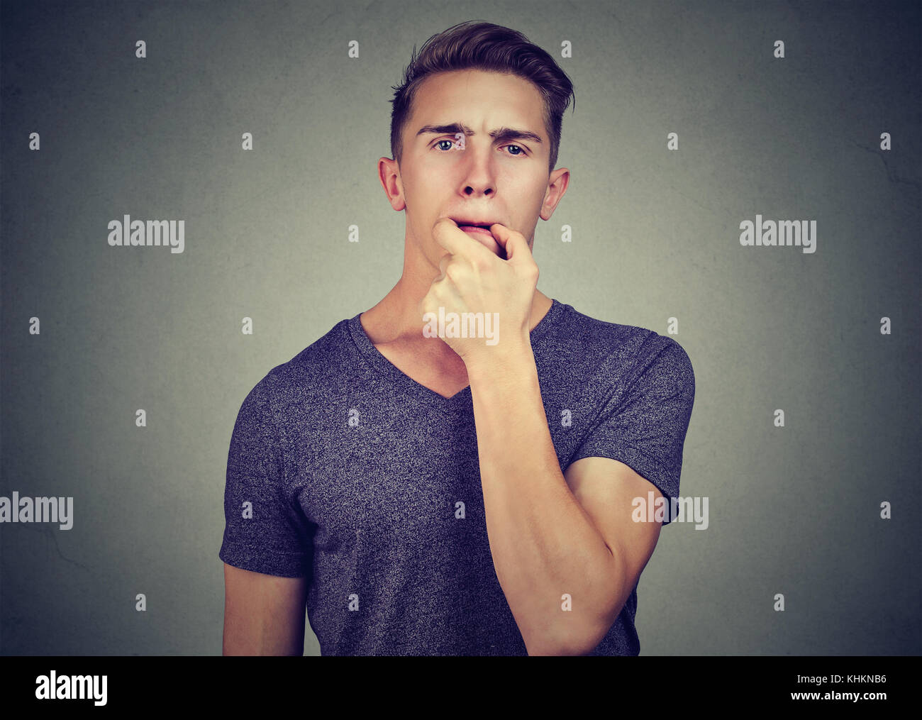 Young man trying to whistle isolated on gray wall background Stock ...