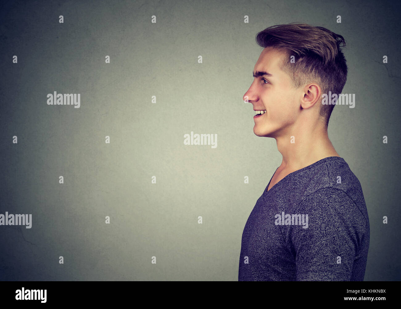 Side profile portrait of a happy man laughing isolated on gray ...