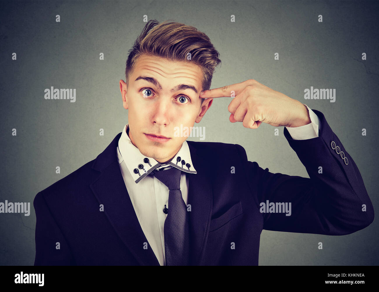 Portrait of angry mad young man gesturing with finger asking are you ...