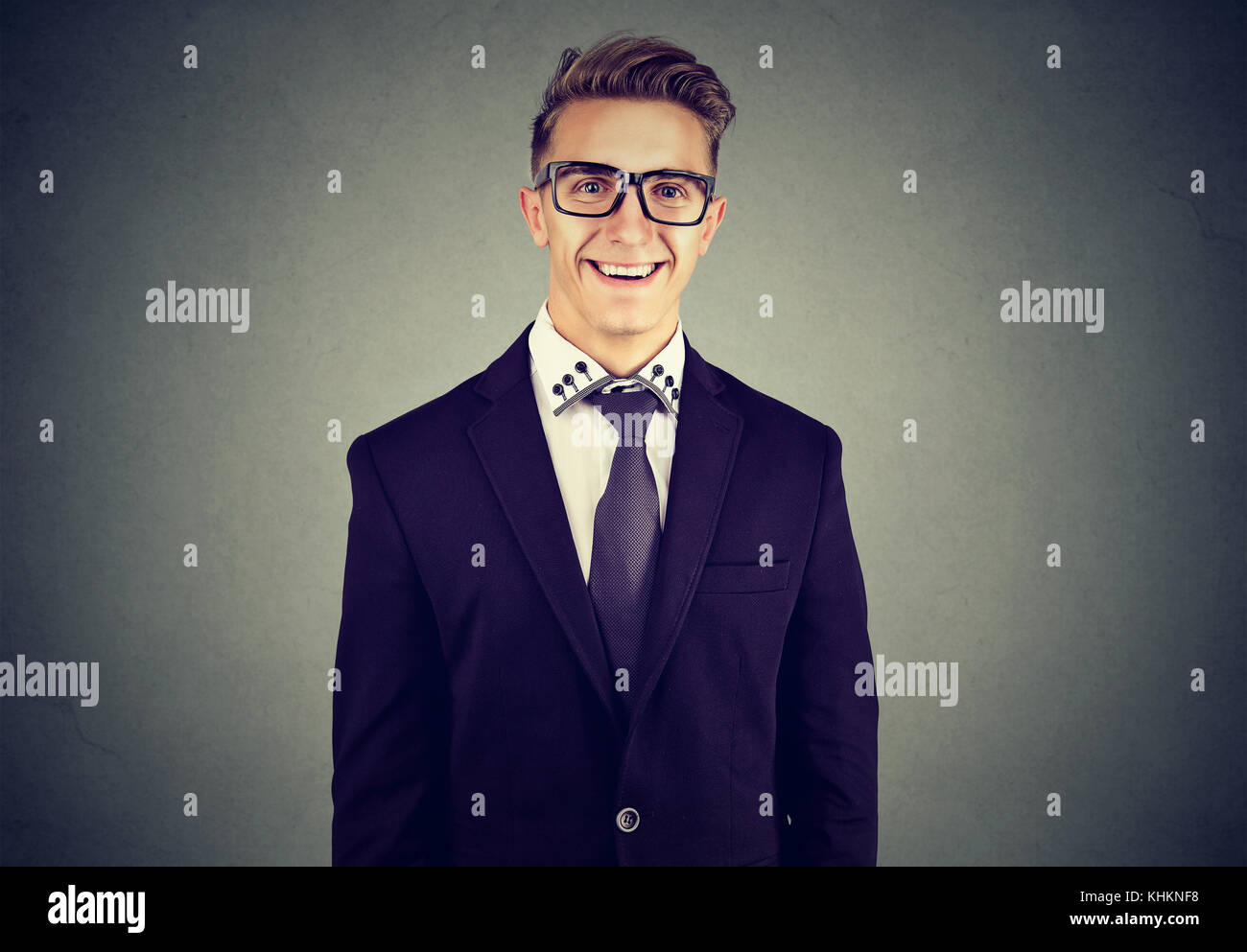 Laughing Funny Looking Handsome Businessman In Glasses On Gray Wall