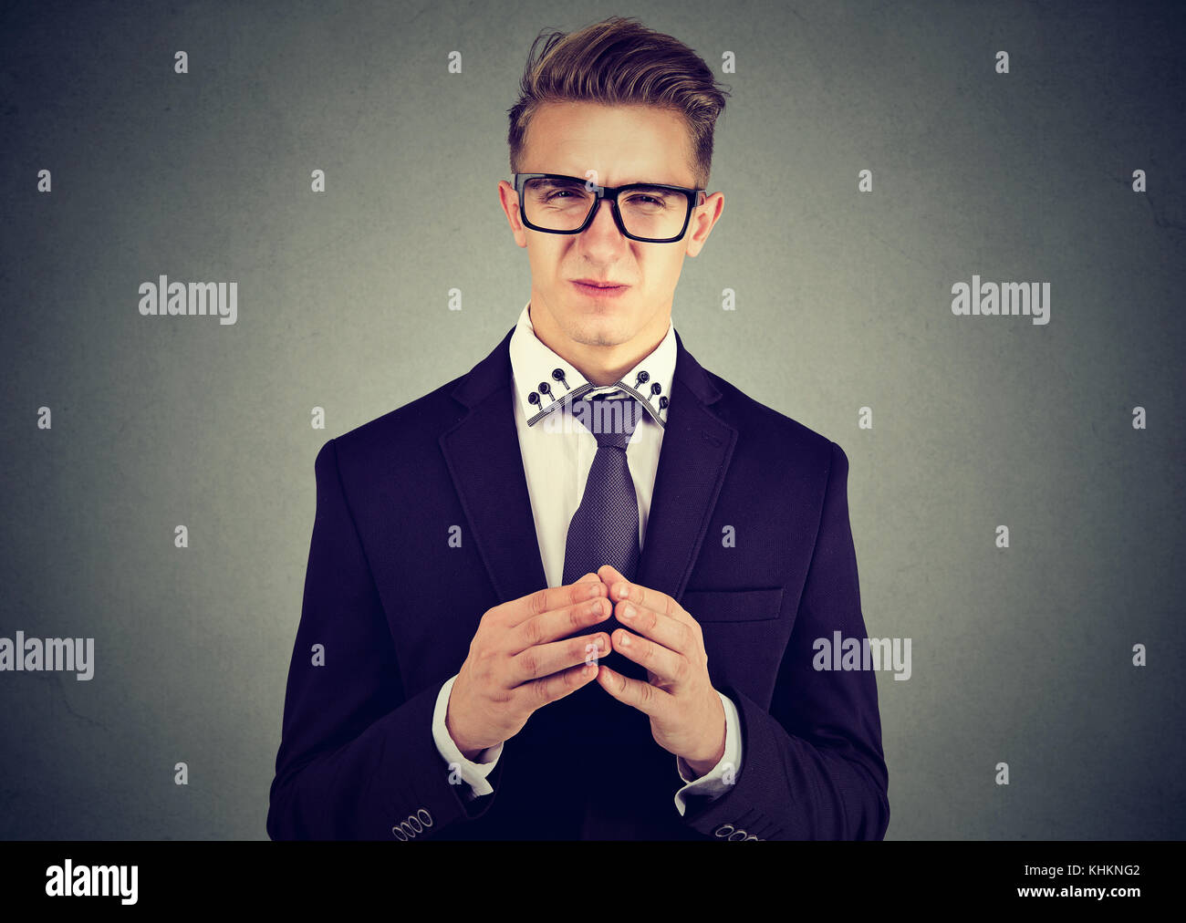 Sly business man in glasses looking at camera Stock Photo - Alamy