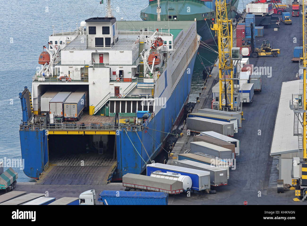 Trucks Transport Docked Ferry in Cargo Port Stock Photo - Alamy