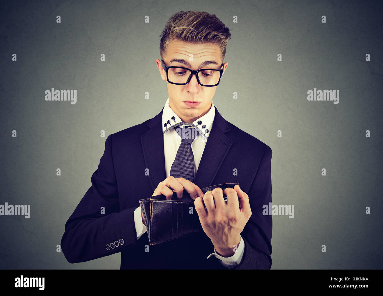 Sad worried business man looking into his wallet with no money Stock ...