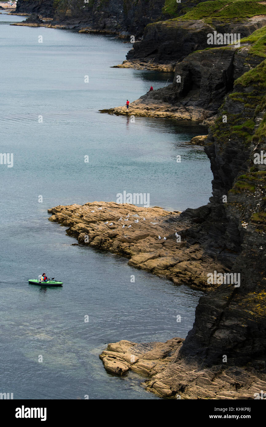 A kayaker exploring the inlets and hidden coves and caves along the ...