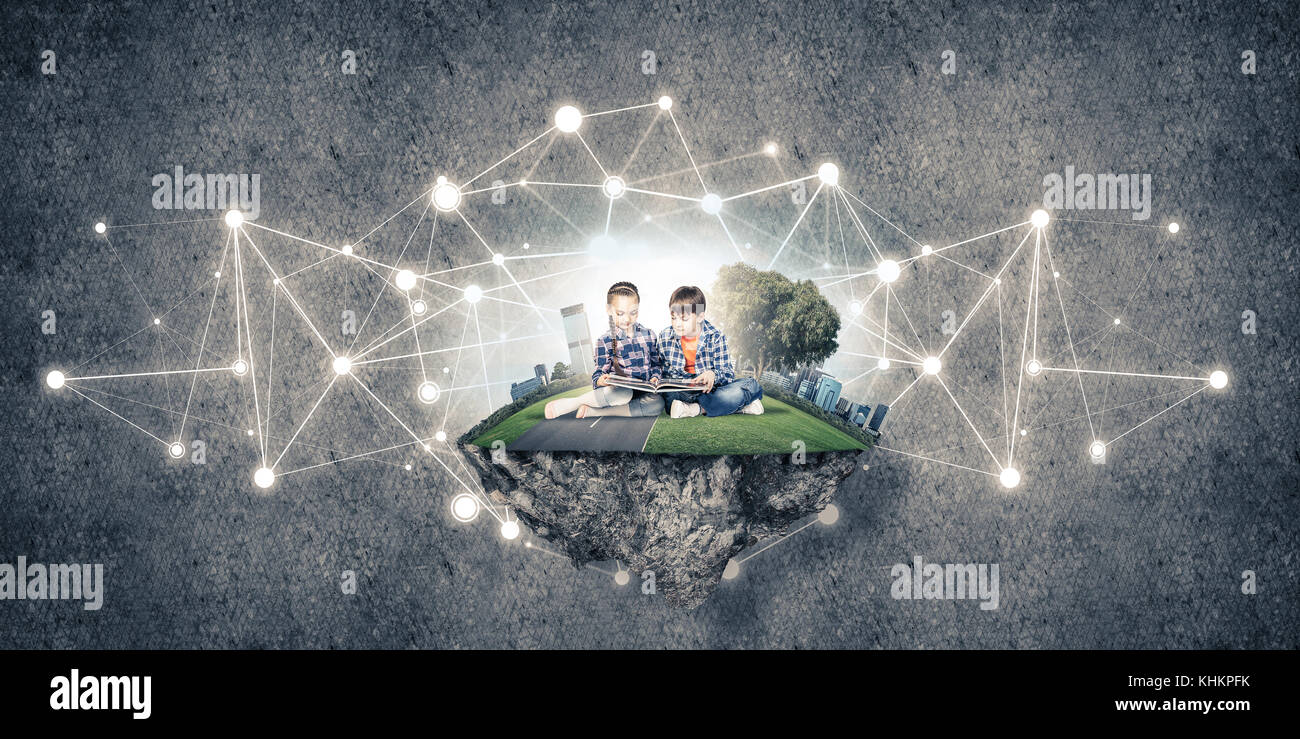 Two kids of school age with book exploring this great world Stock Photo ...