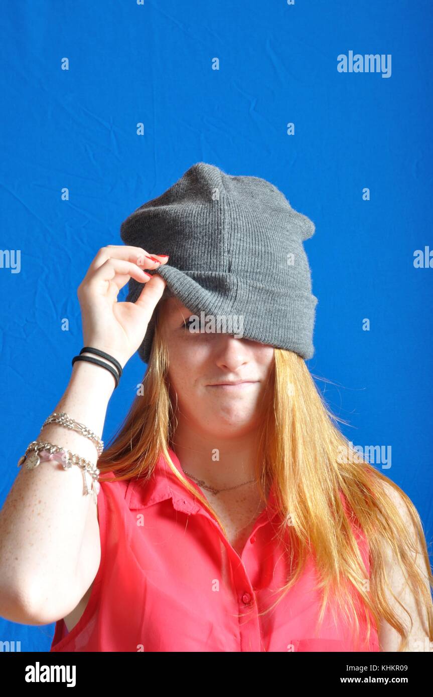 Teen hiding his face with his bonnet Stock Photo - Alamy