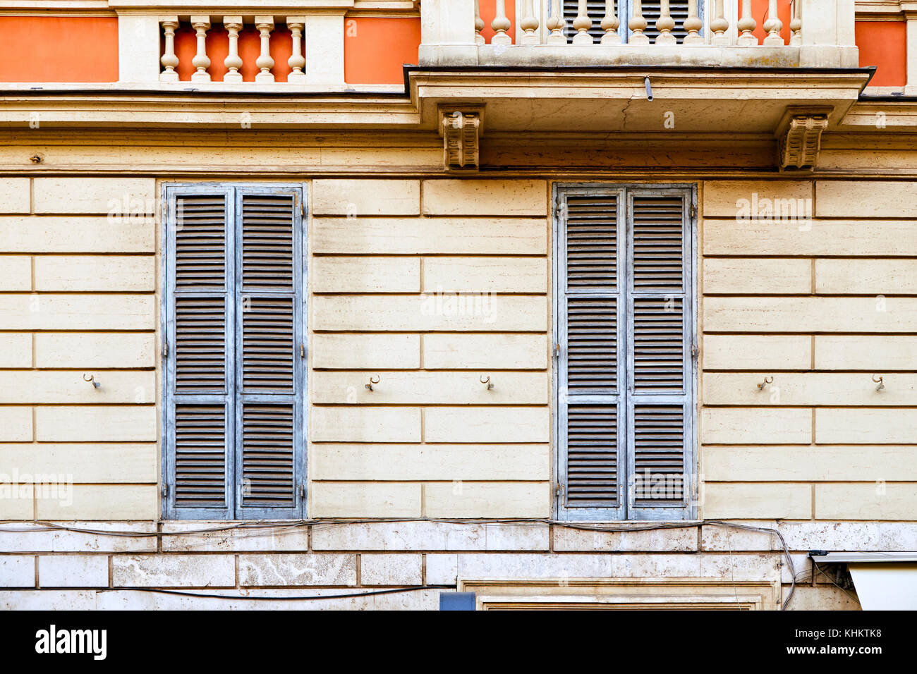 Two windows shut with blue shutters. Part of one of the buildings in ...