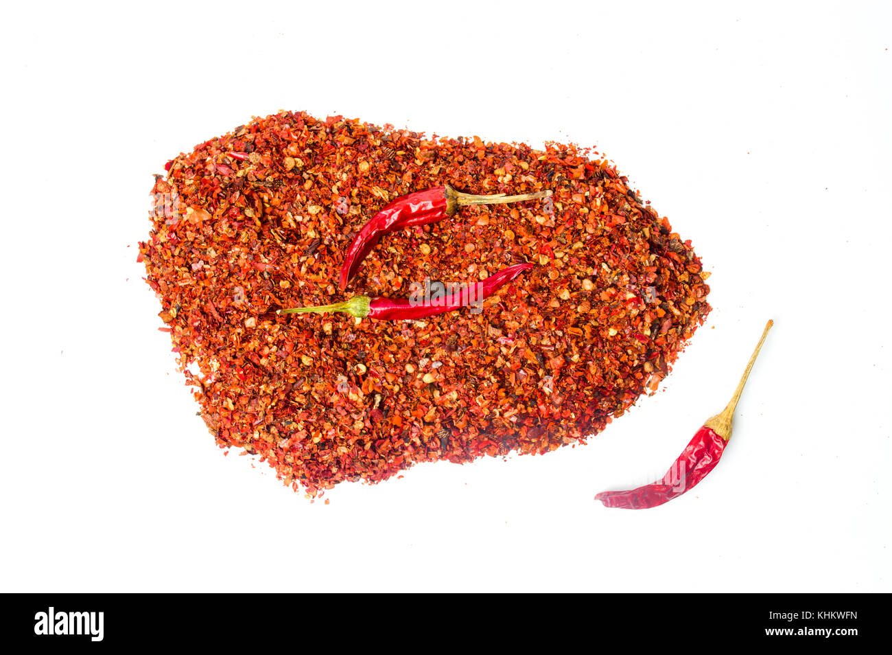 Smashed red pepper powder on a pile isolated on white Stock Photo - Alamy