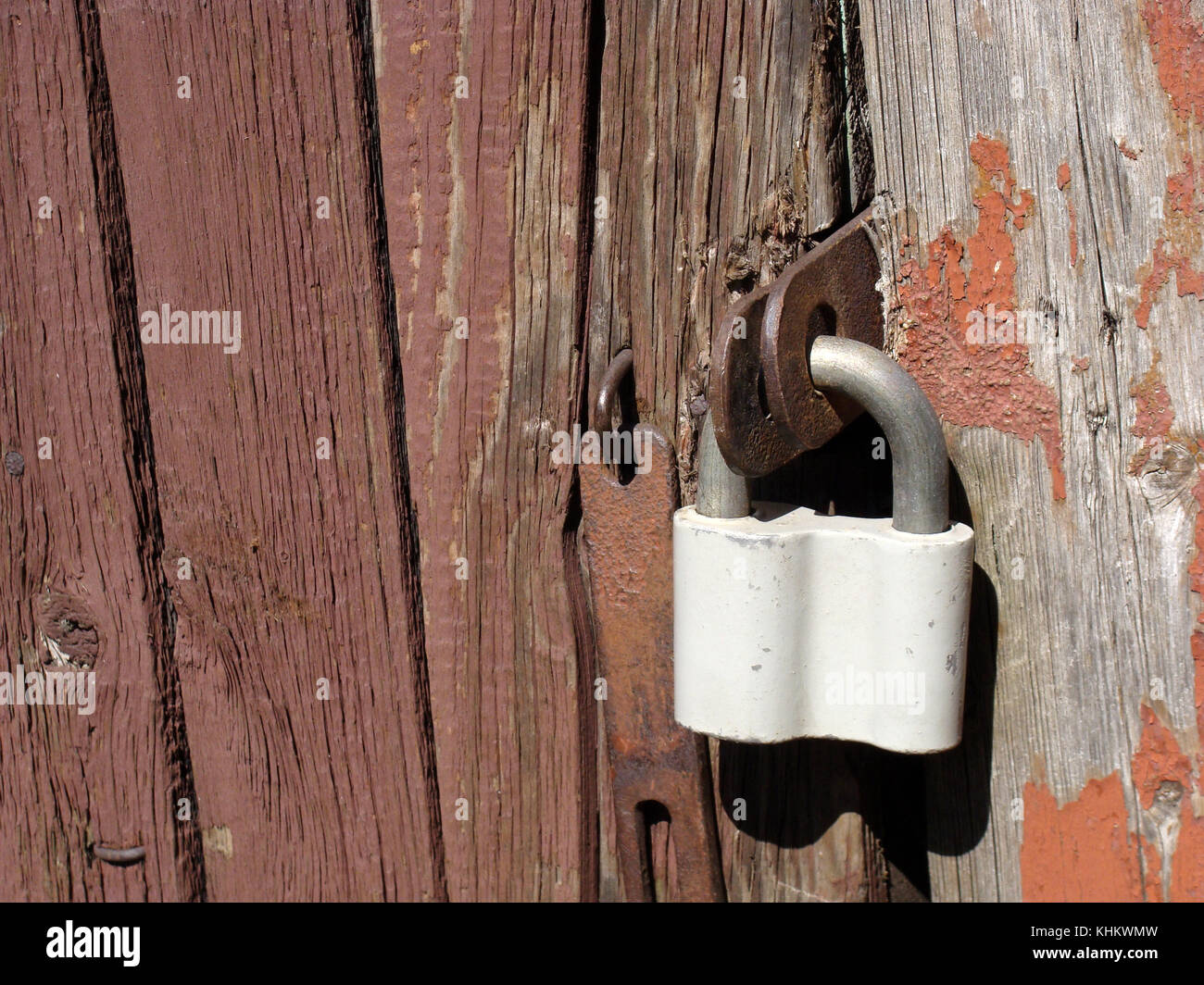 Old brown wooden barn doors locked by solid iron padlock Stock Photo ...