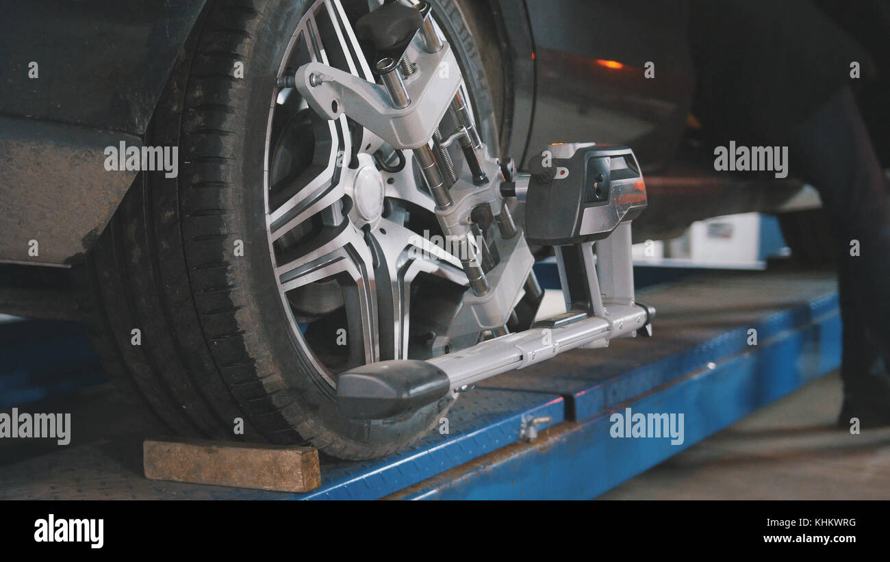Checking the wheel in garage automobile service, close up Stock Photo ...