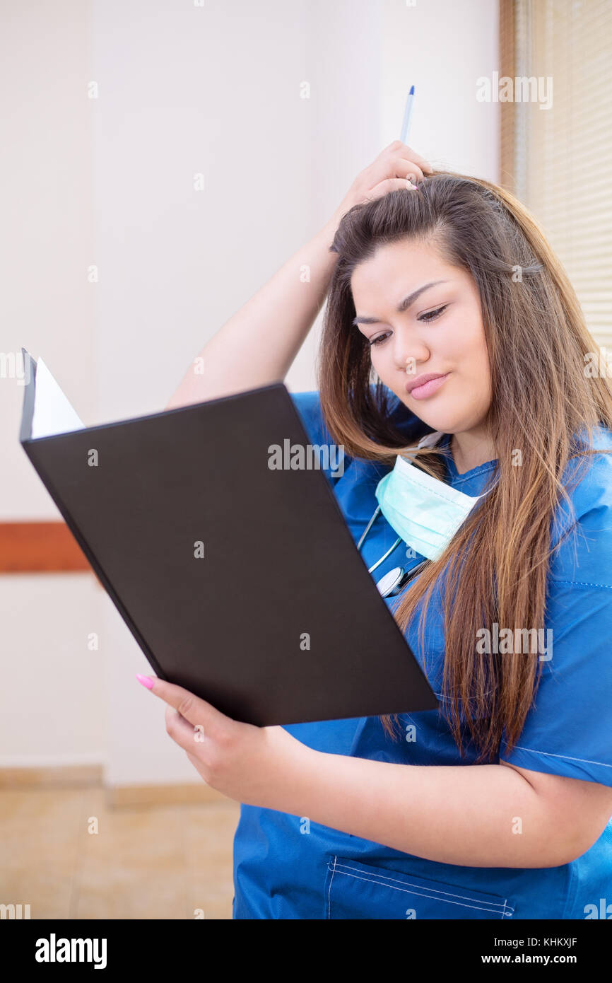 Close-up photo of confused female doctor reading a medical report ...