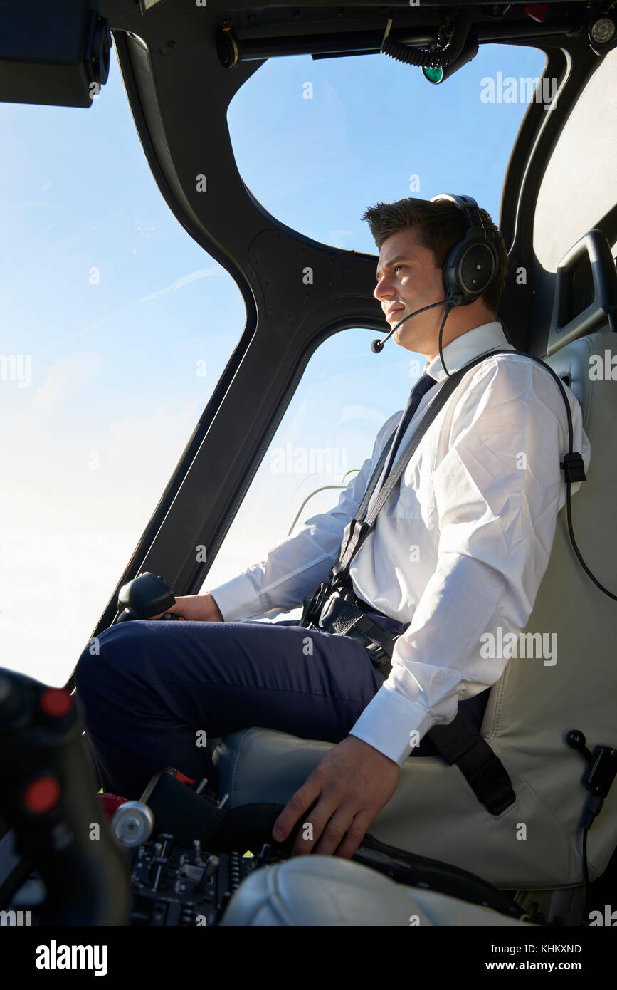 Pilot In Cockpit Of Helicopter During Flight Stock Photo - Alamy