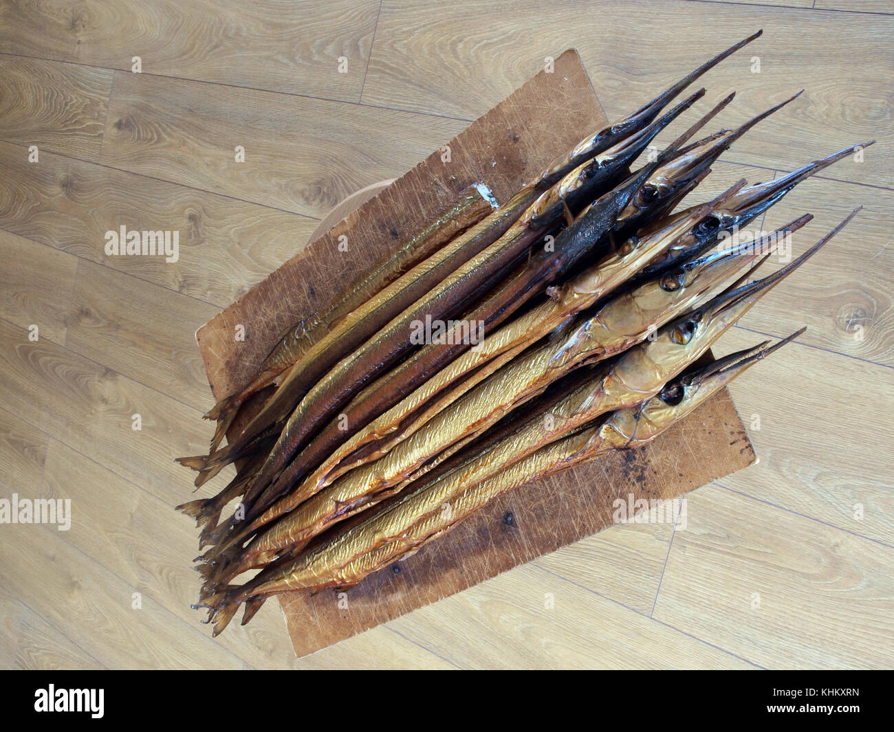 Stack of big smoked garfishes top view close up Stock Photo - Alamy