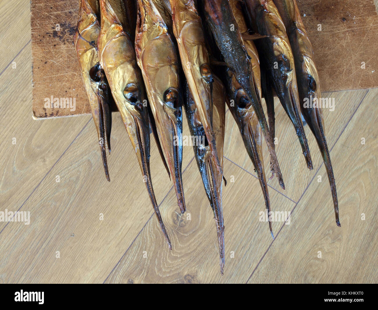 Heads of big smoked garfishes top view close up Stock Photo - Alamy